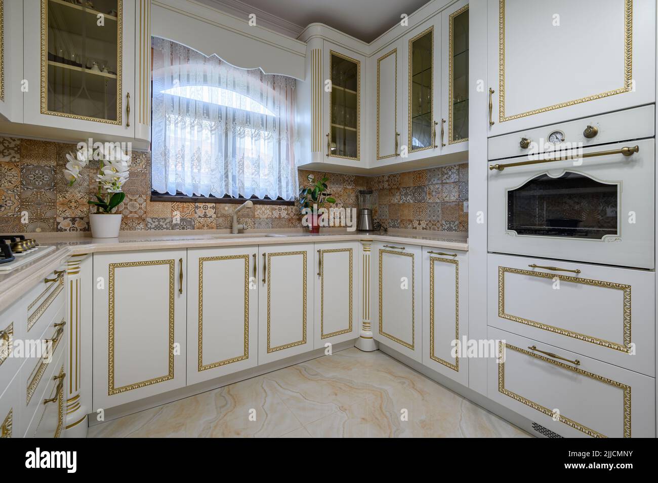 White classic cozy kitchen and dining room in city house Stock Photo ...