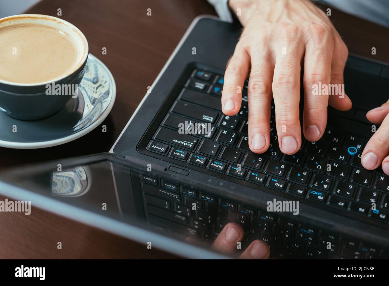 coffee break work man hands typing laptop cup Stock Photo - Alamy