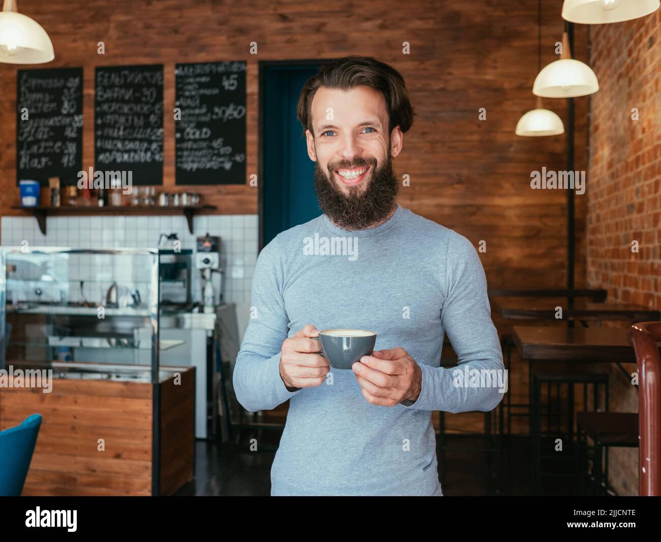 man stand coffee shop cup casual business owner Stock Photo - Alamy