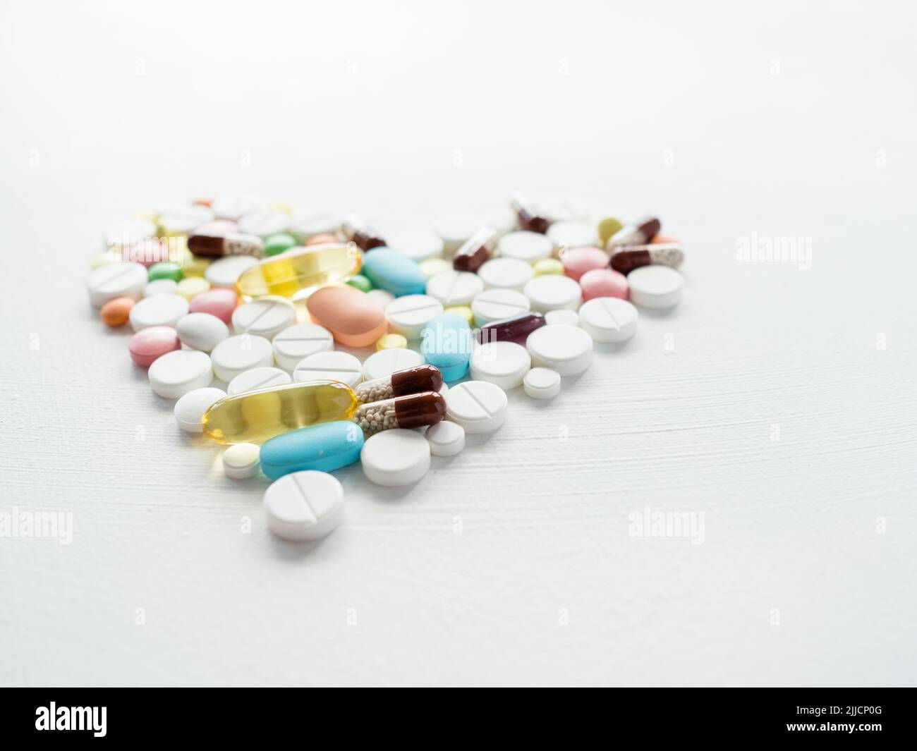 pill mix heart shape painkiller prescription drugs Stock Photo - Alamy