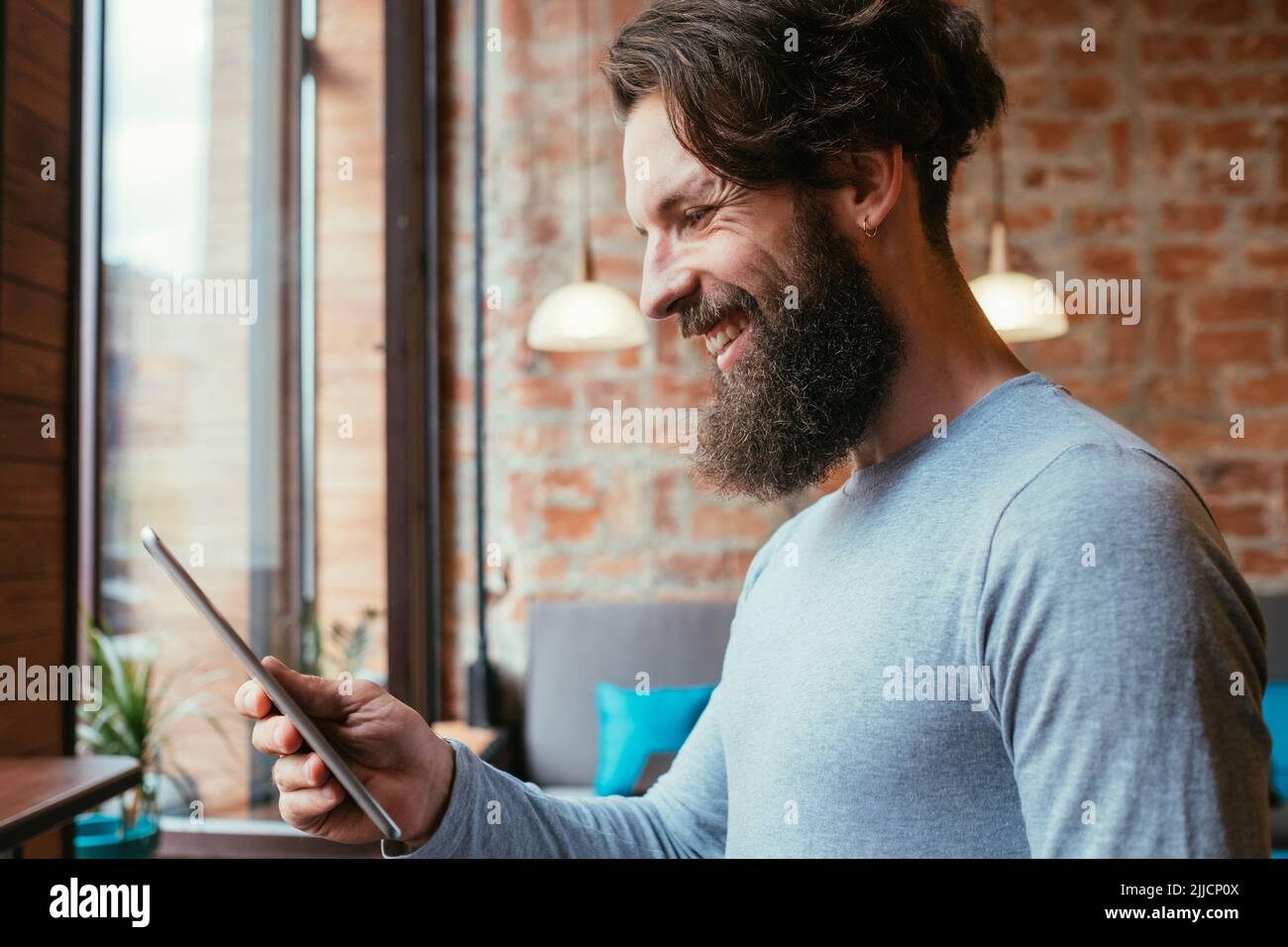 focused man reading tablet knowledge access info Stock Photo - Alamy