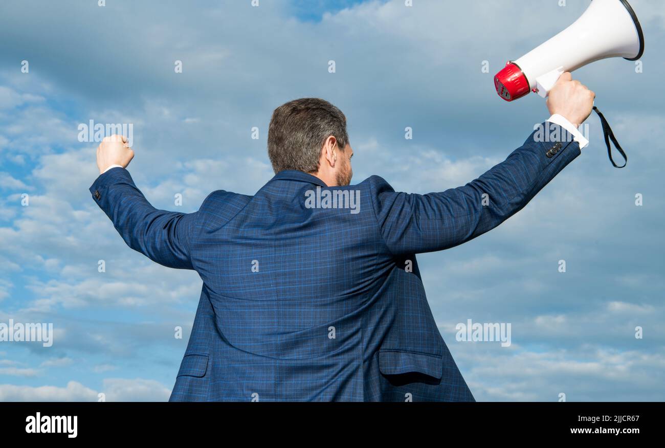 back view of businessman hold megaphone on sky background Stock Photo ...