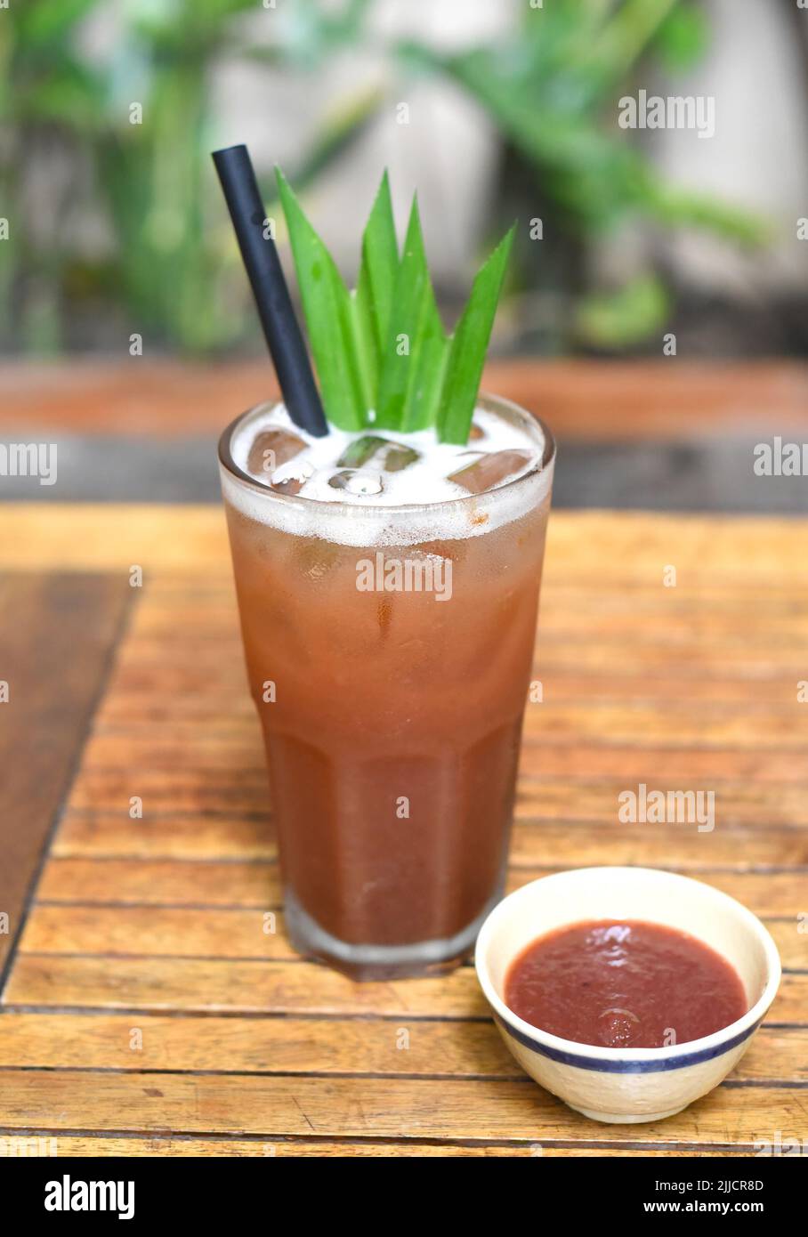 Iced plum tea with jam on wooden planks table Stock Photo - Alamy