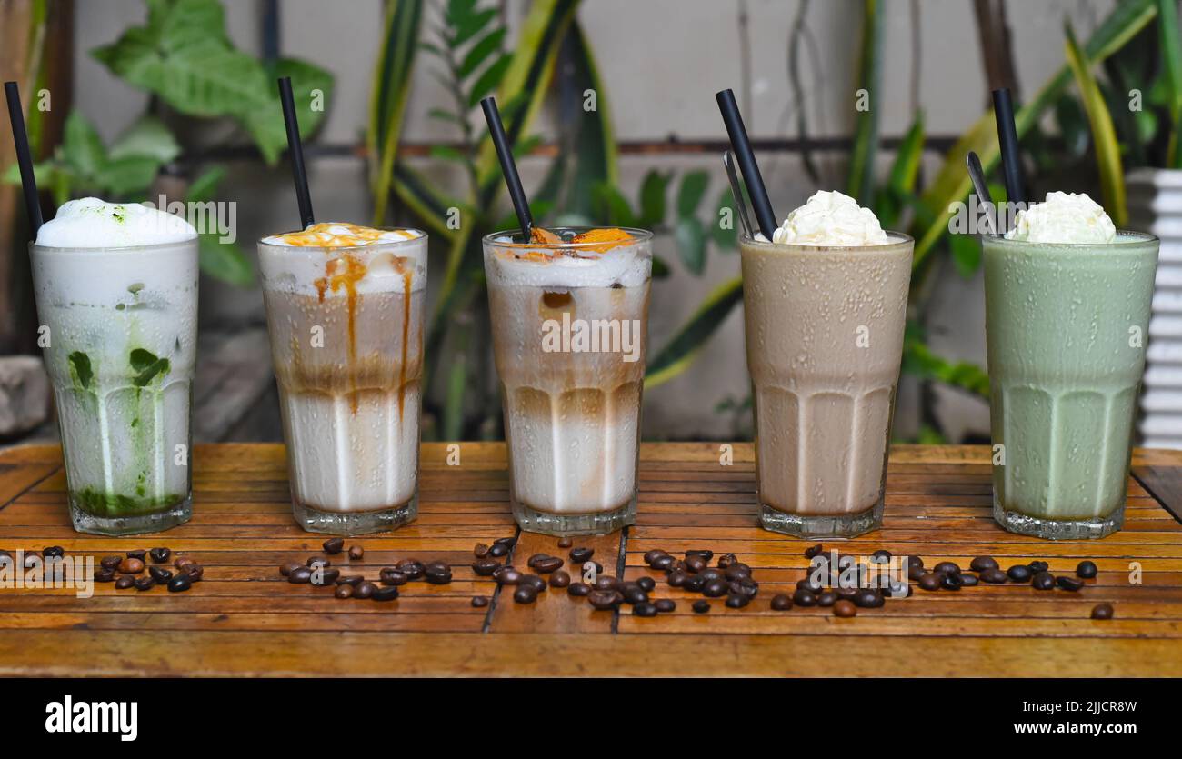 Coffee beverages with coffee beans on wooden table in a coffee shop ...