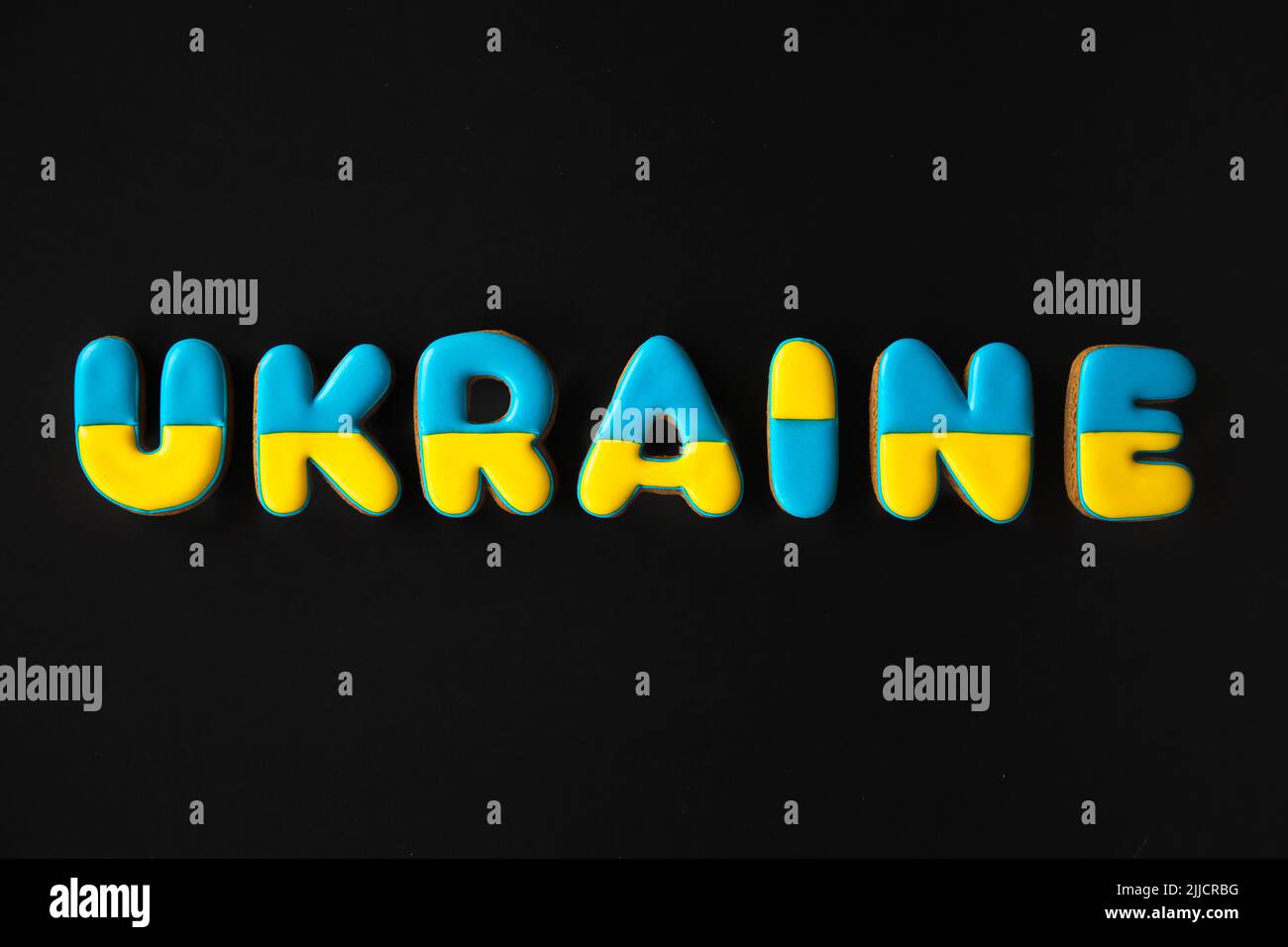 The word Ukraine on a black background, made with handmade gingerbread ...