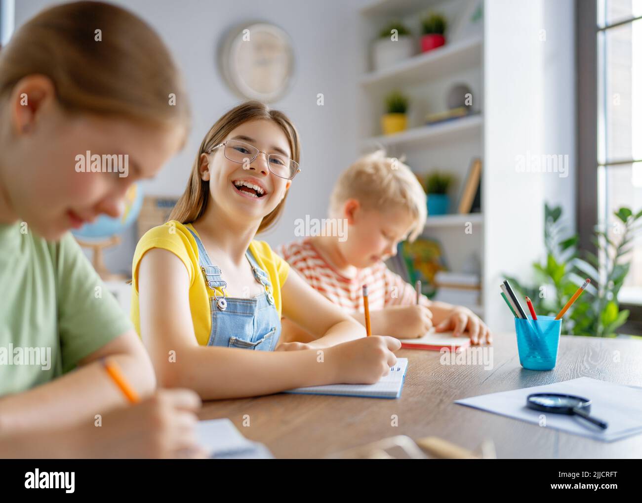 Happy kids at school. Children are working in the class Stock Photo - Alamy