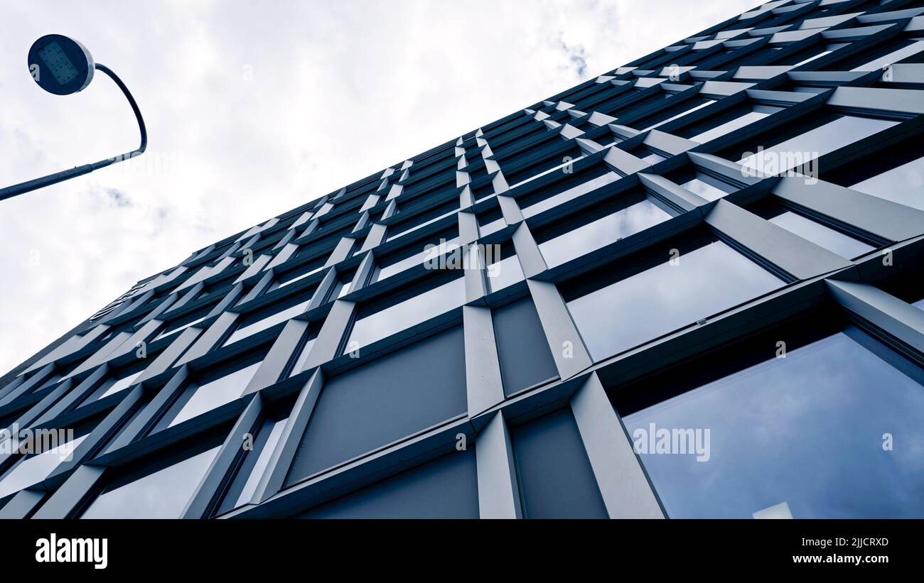 a perspective view of a tall glass building with a clear sky in ...
