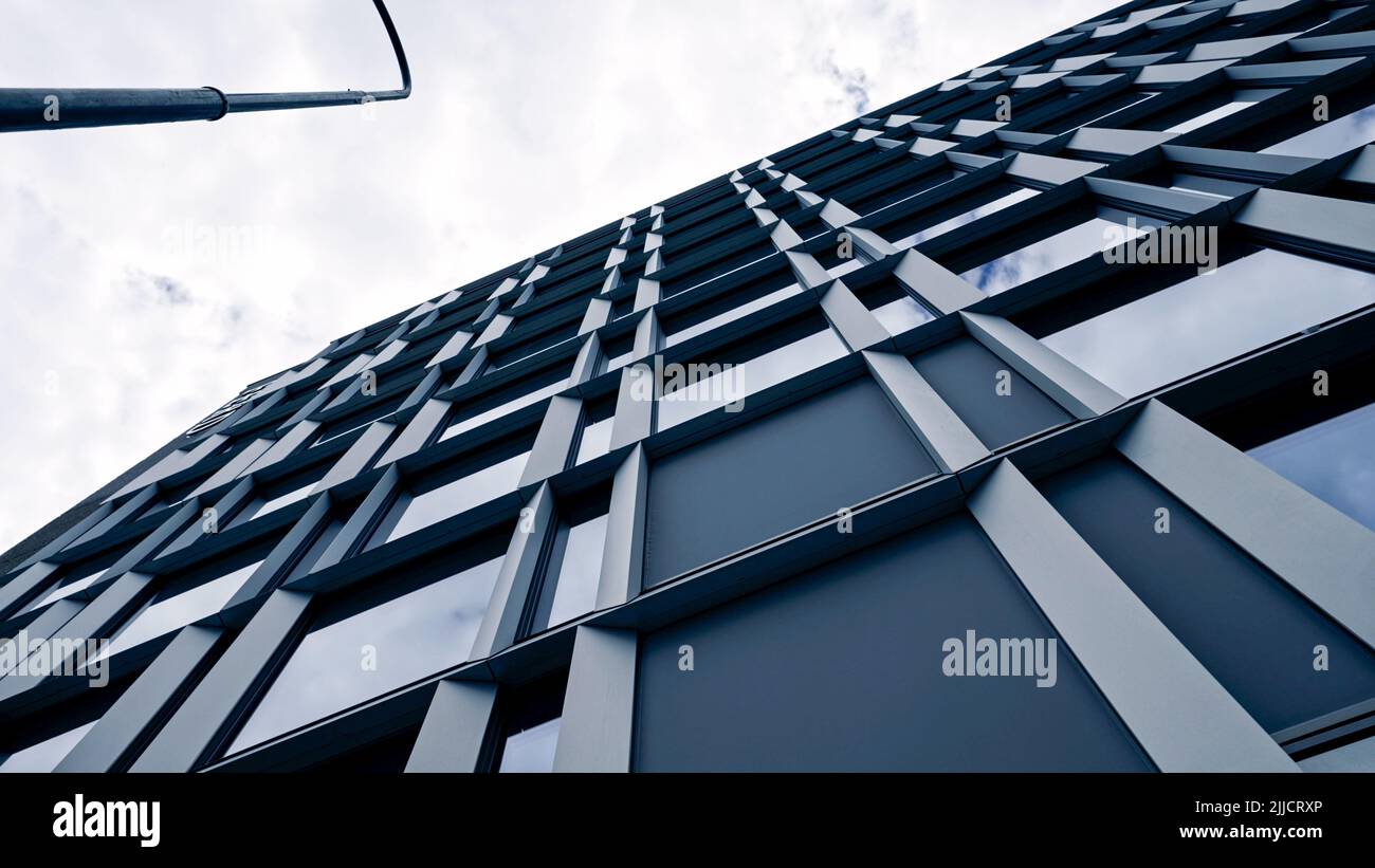 a perspective view of a tall glass building with a clear sky in ...