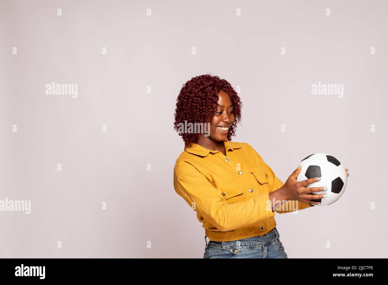 African model holding a football hi-res stock photography and images ...