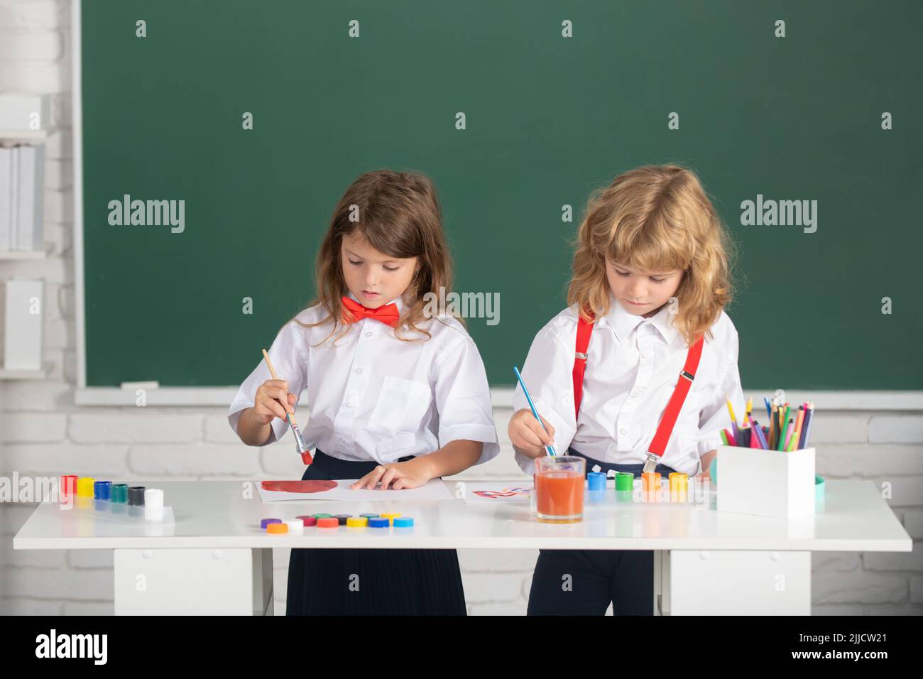 Kids creative growth. Portrait school kids doing art homework. Children ...