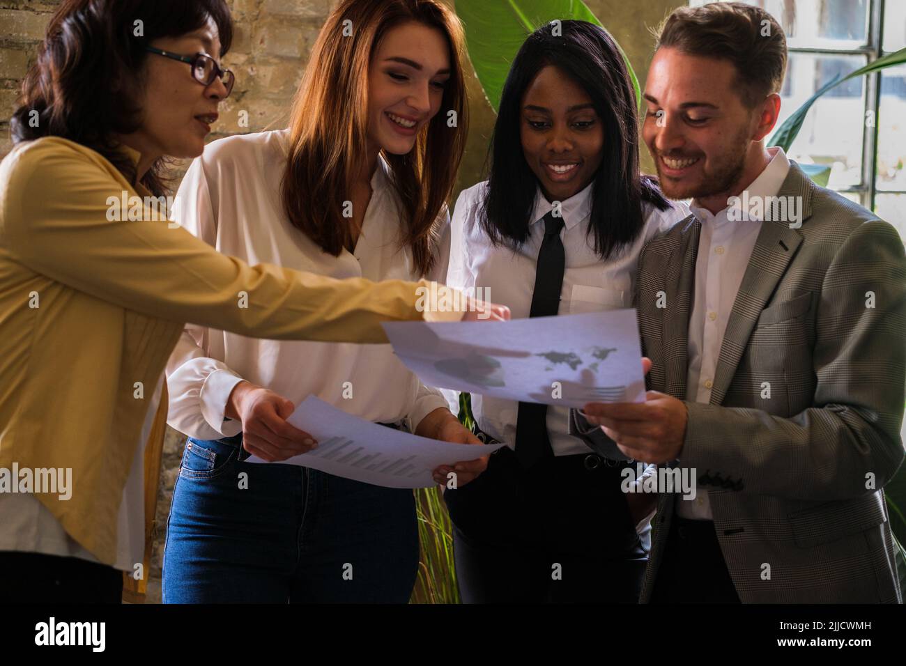 Group of workers doing office work standing with charts Stock Photo - Alamy