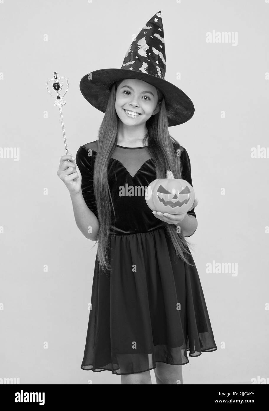 happy witch child with magic wand and pumpkin jack o lantern wear ...