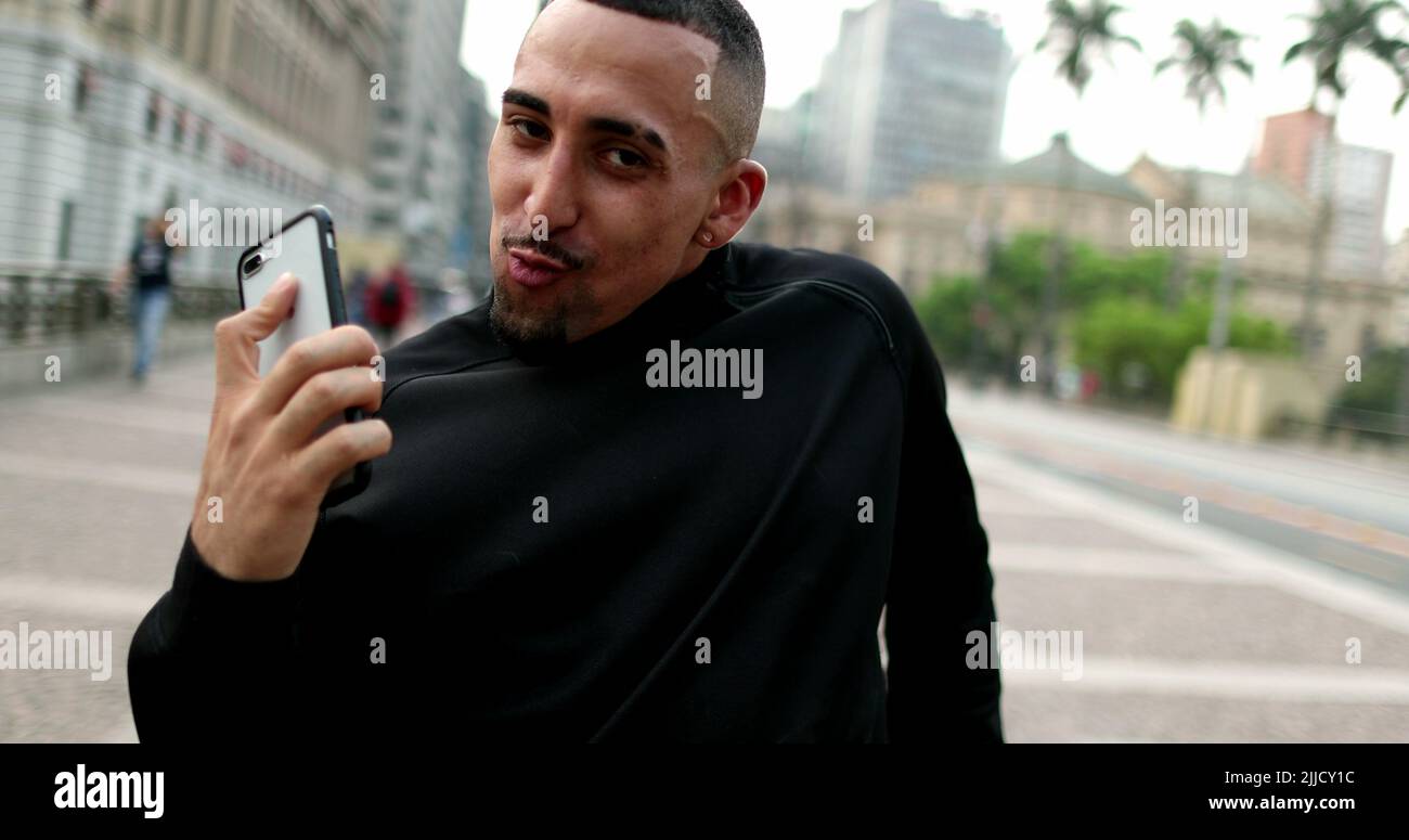Happy hispanic man dancing in street. Excited latin guy dances in joy ...