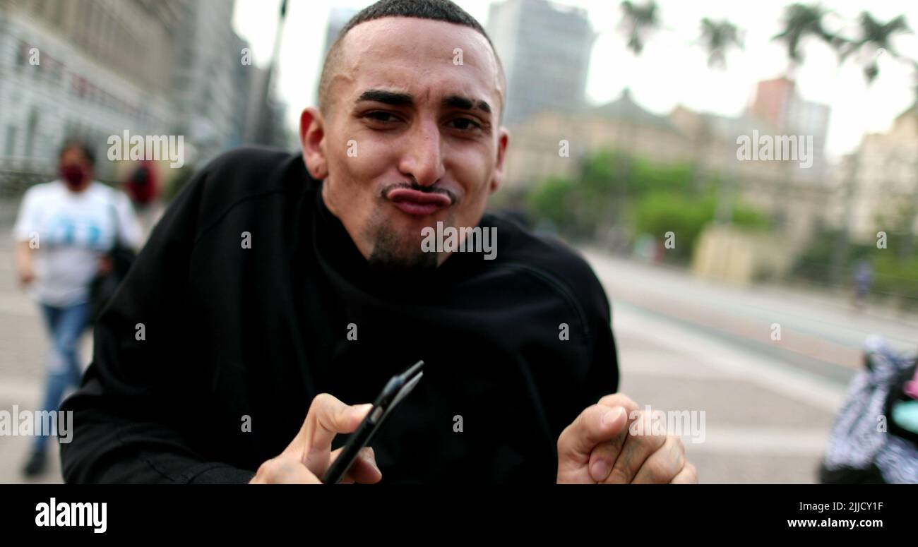 Happy hispanic man dancing in street. Excited latin guy dances in joy ...