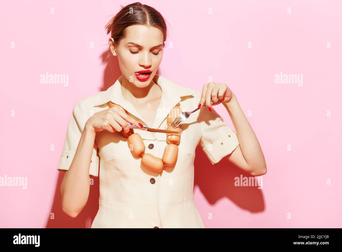 Image of woman eating necklace made from sausages. Creative food ...