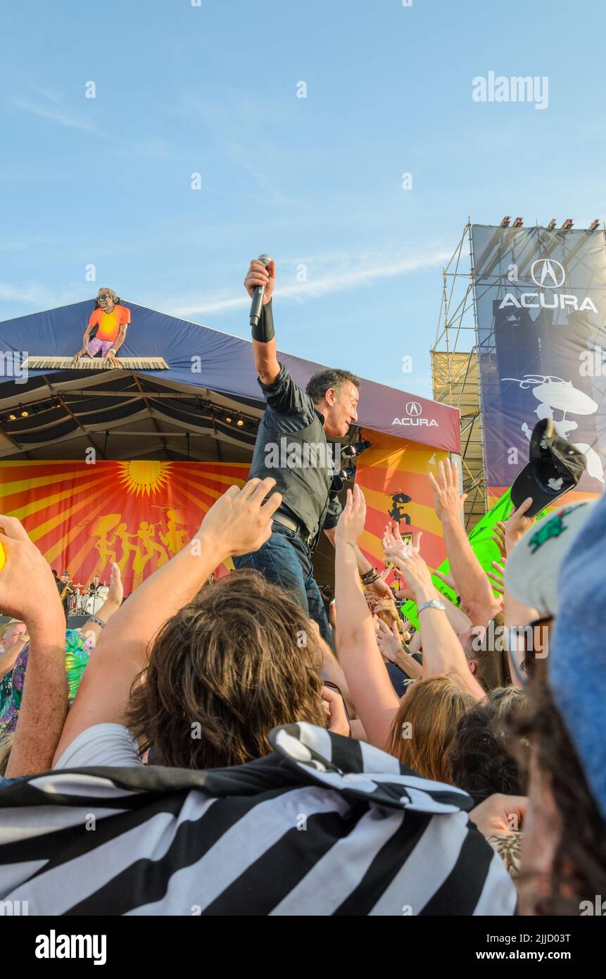 Bruce Springsteen performs with extended microphone in hand amidst the ...