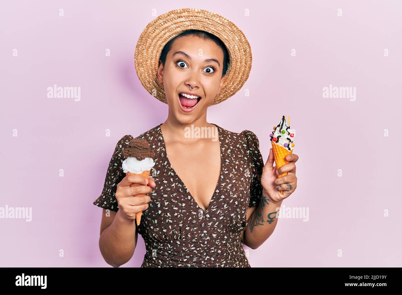 Beautiful hispanic woman with short hair eating ice cream cones afraid ...