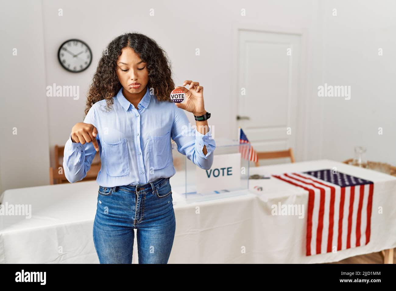 Beautiful hispanic woman standing by at political campaign by voting ...