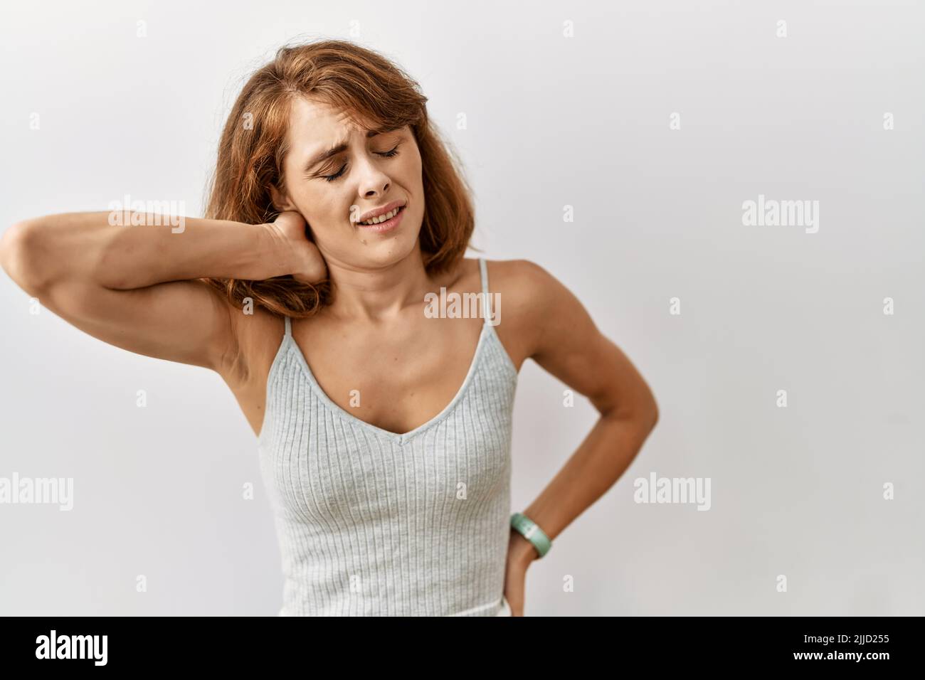 Beautiful caucasian woman standing over isolated background suffering ...