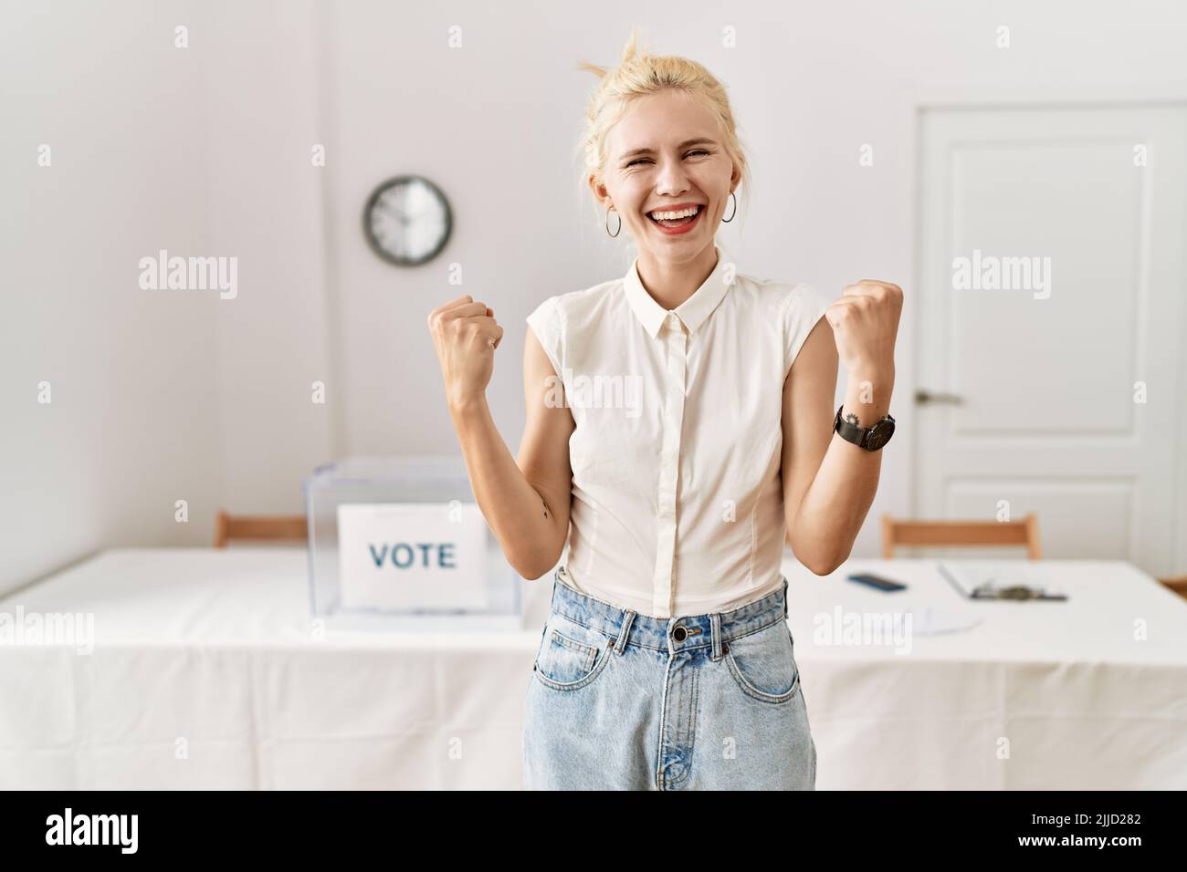Beautiful caucasian woman standing by voting ballot at election room ...