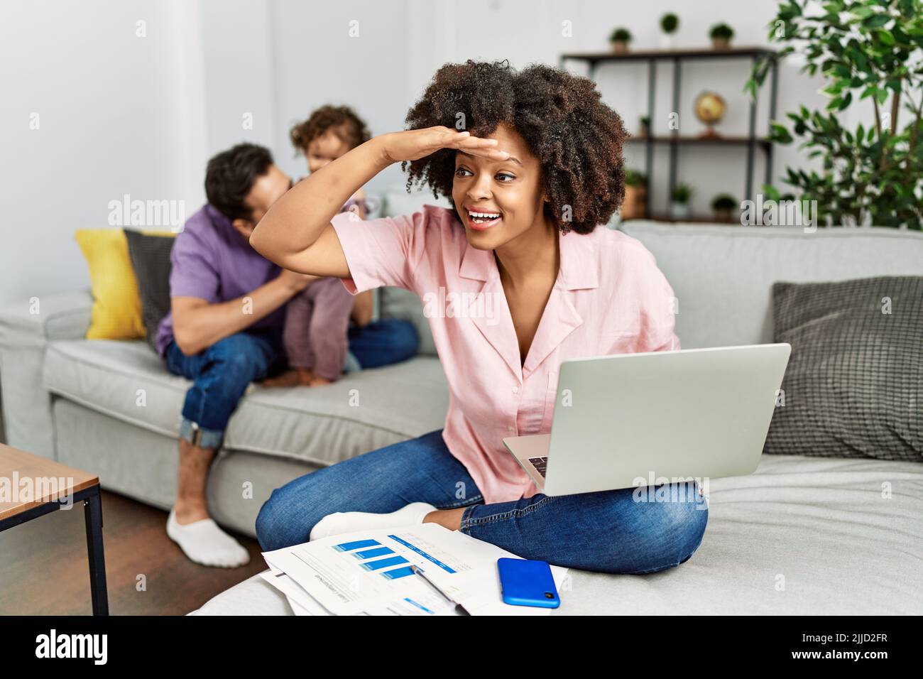 Mother of interracial family working using computer laptop at home very ...