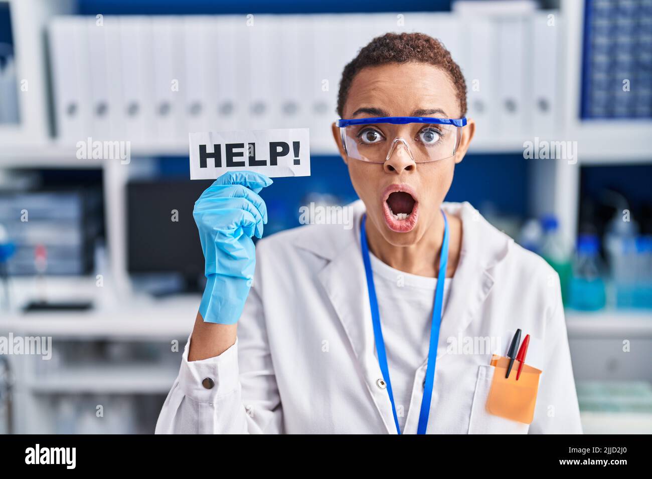 Beautiful african american woman working at scientist laboratory asking ...