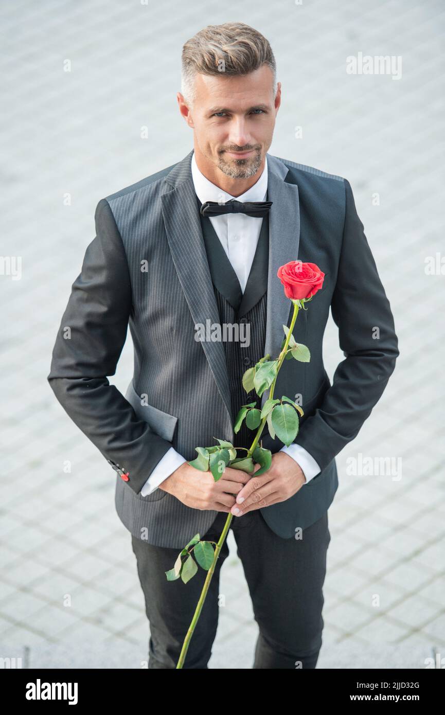 elegant man in tux. man wearing tux suit outside. charismatic tux man ...