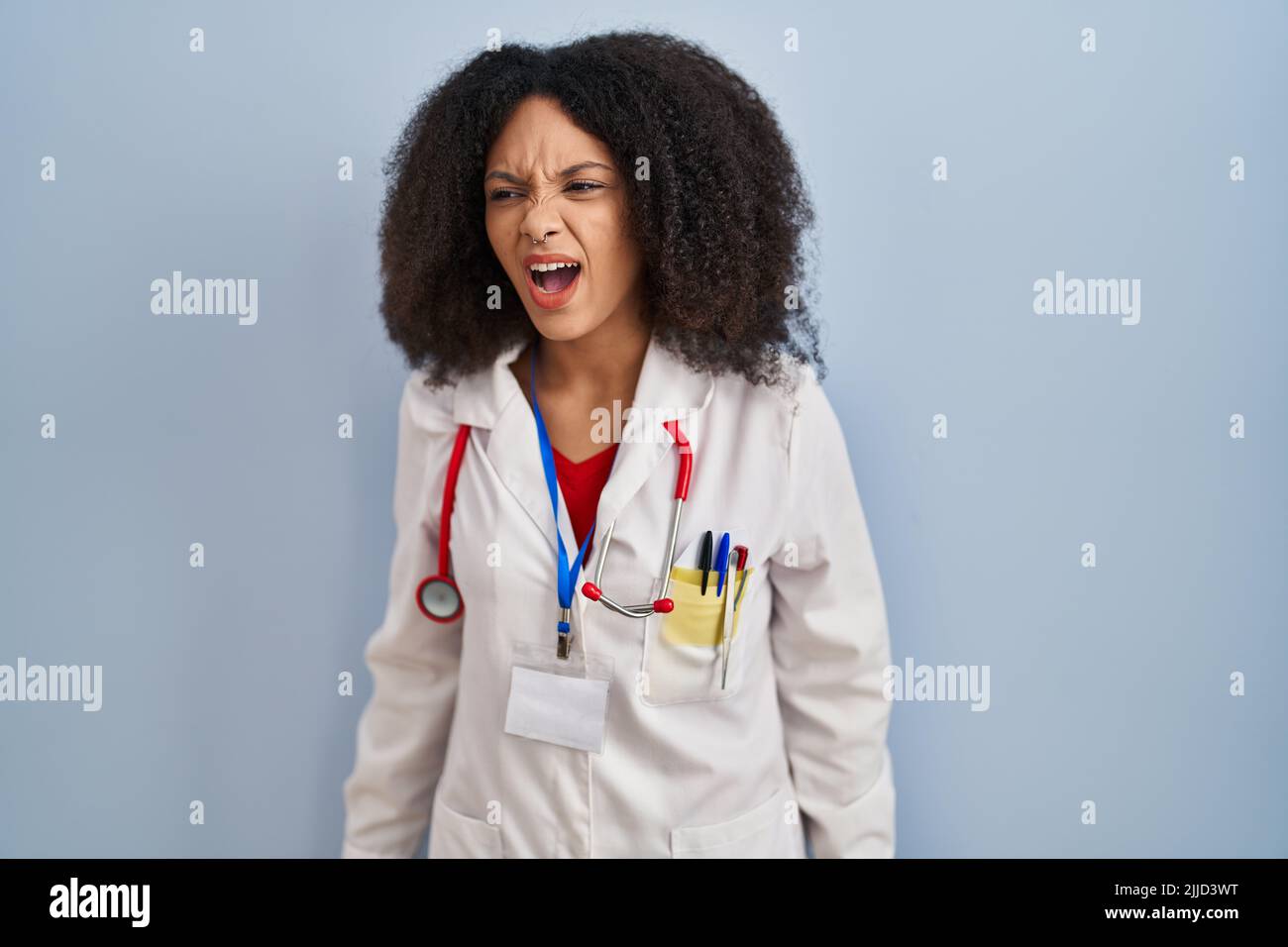 Young african american woman wearing doctor uniform and stethoscope ...