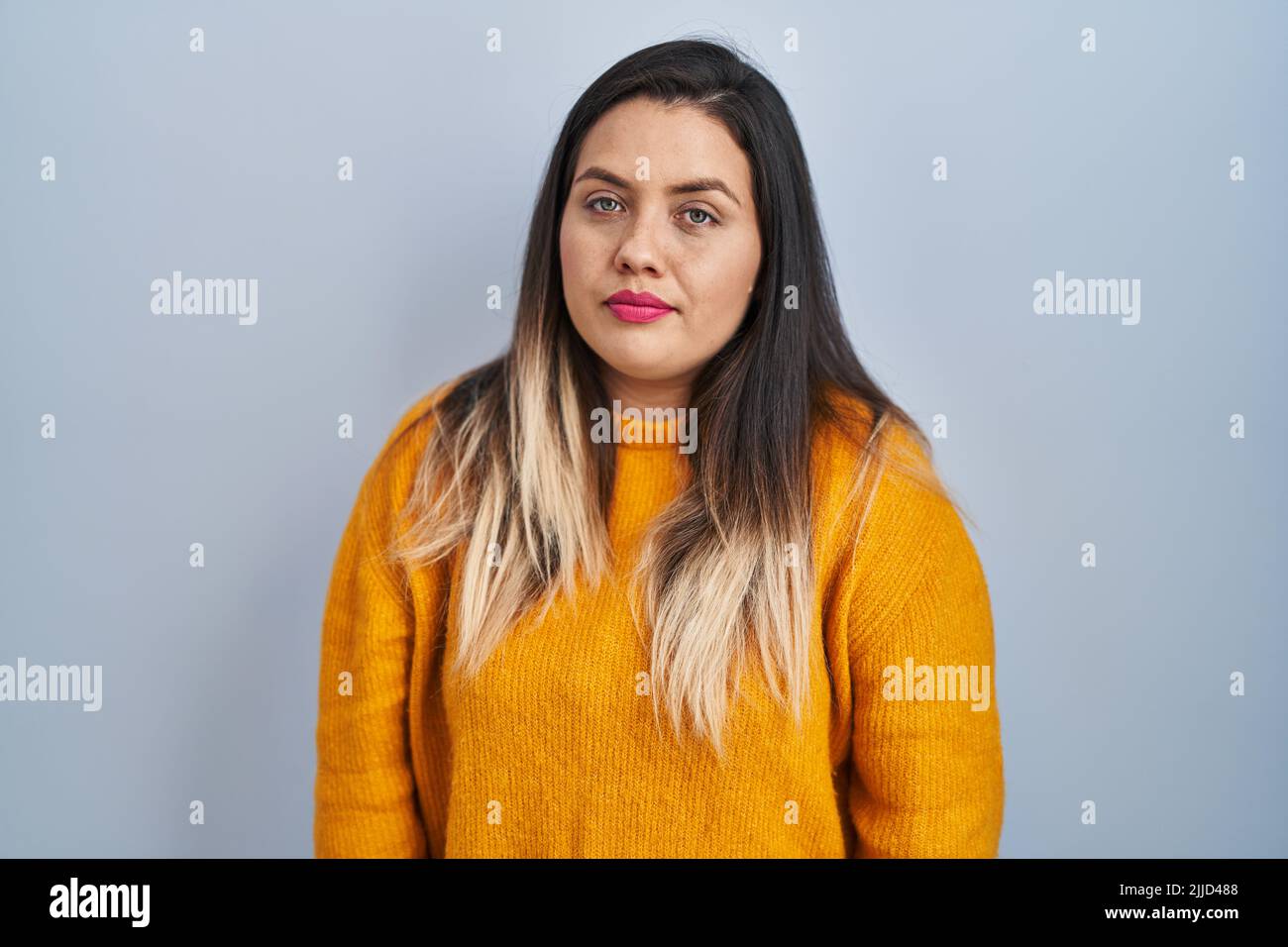 Young hispanic woman standing over isolated background relaxed with ...