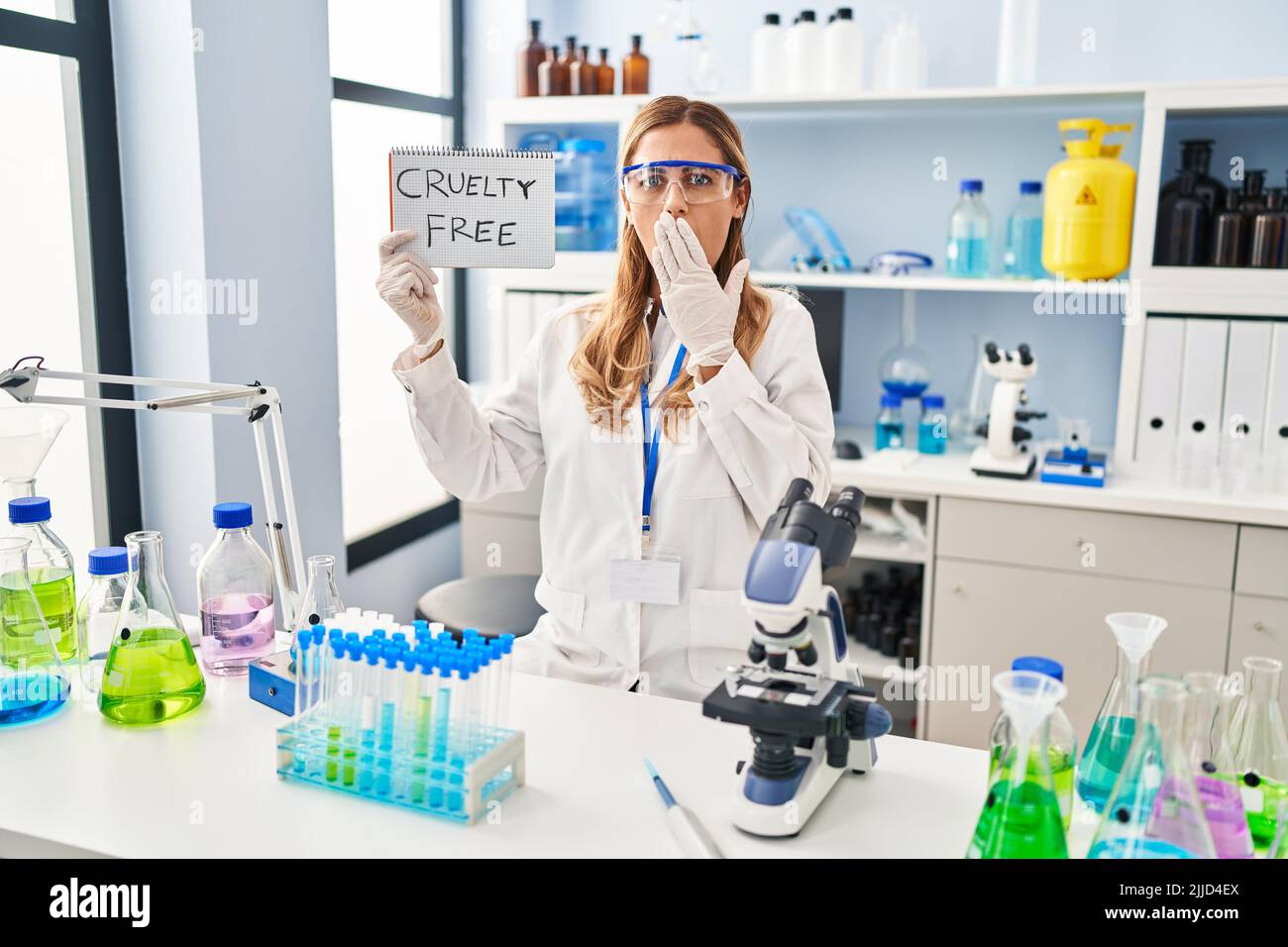 Young blonde scientist woman working on cruelty free laboratory ...