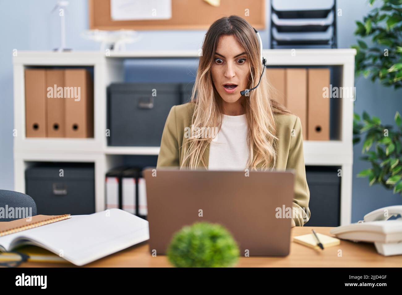Young hispanic woman wearing call center agent headset working at the ...