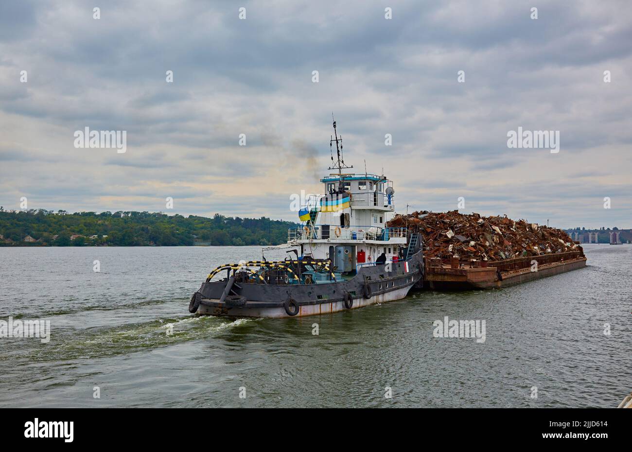 Transportation industry. Ship barge transports scrap metal and sand ...