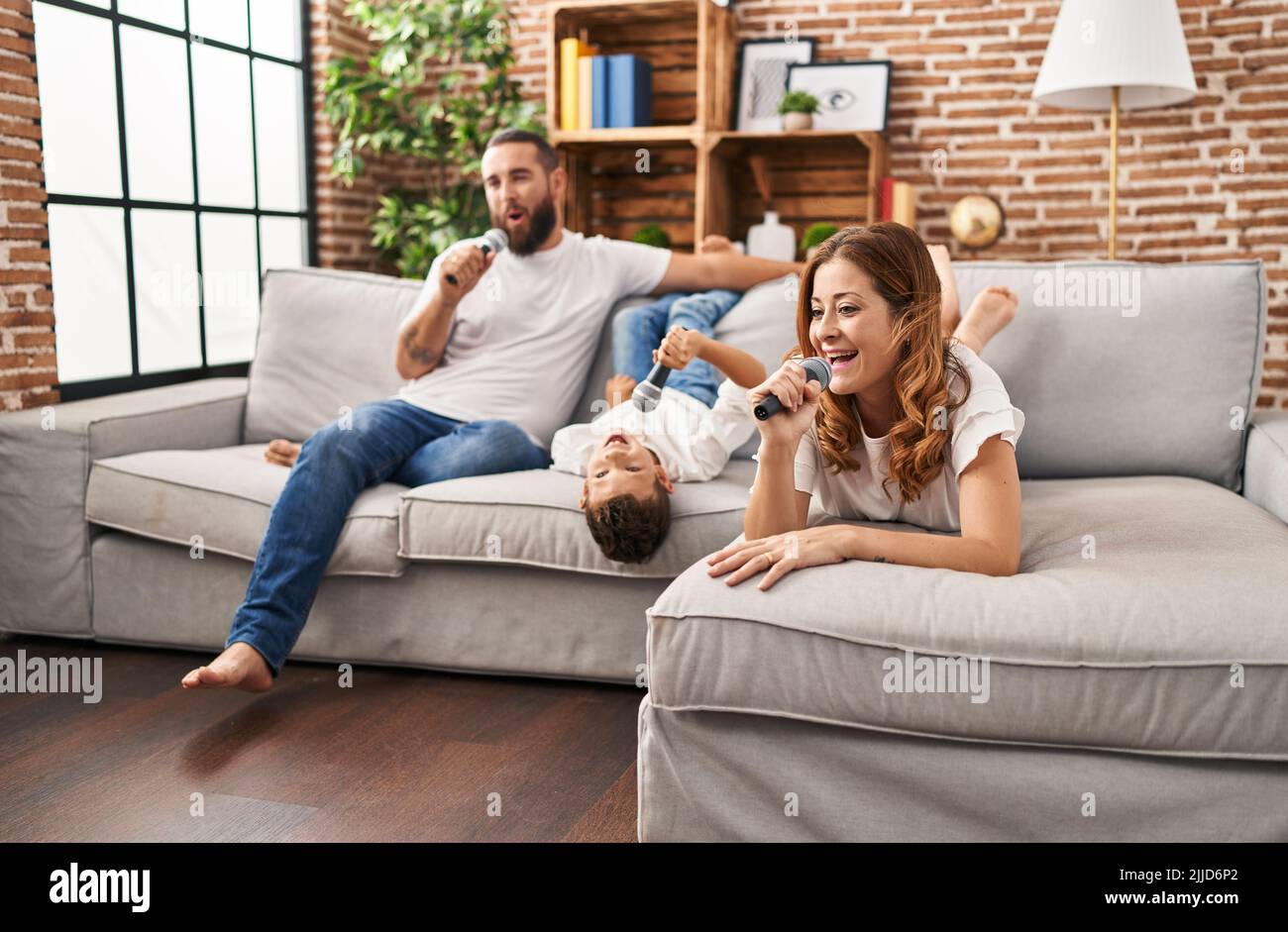 Family singing song using microphone at home Stock Photo - Alamy