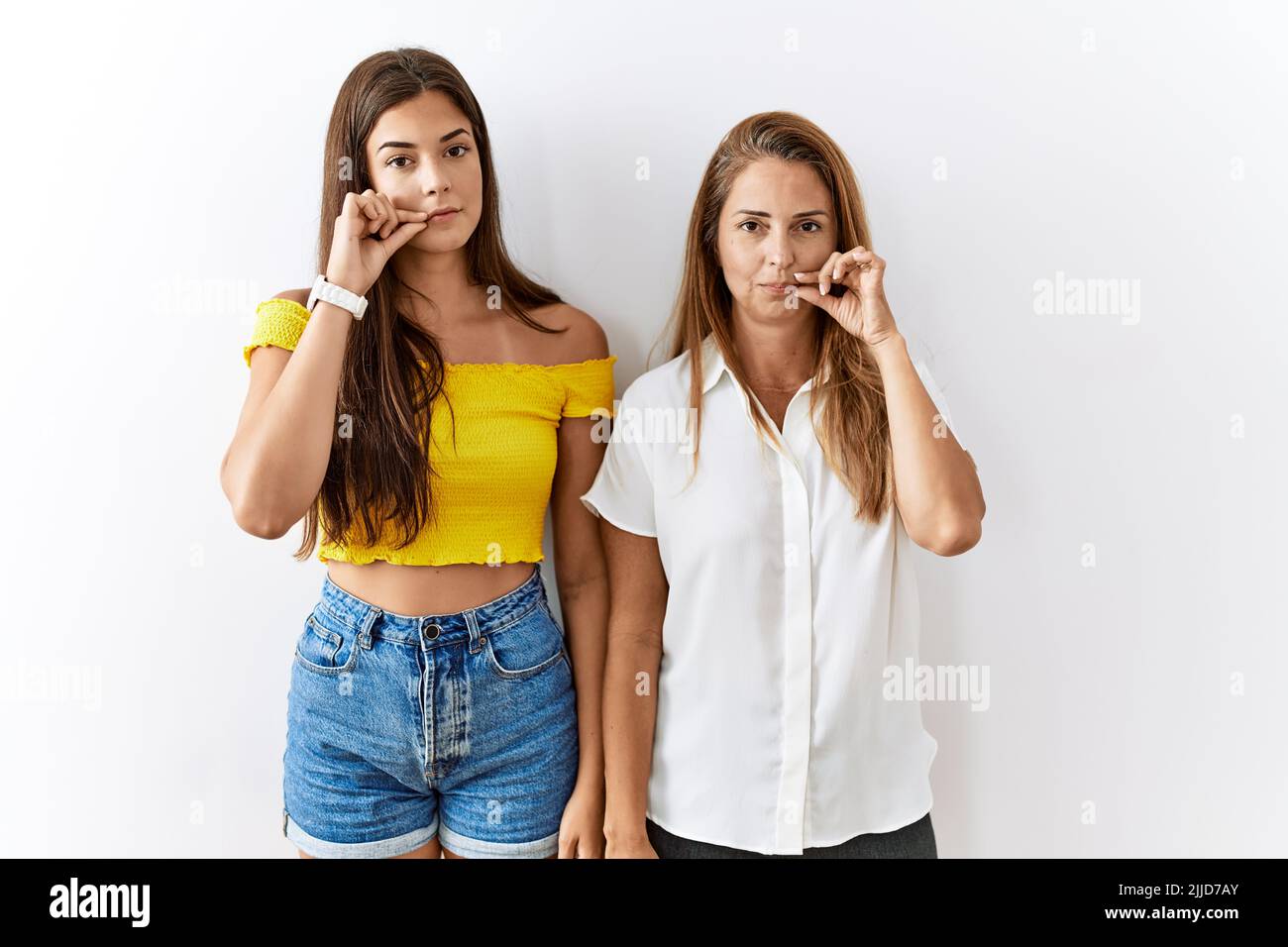 Mother And Daughter Together Standing Together Over Isolated Background