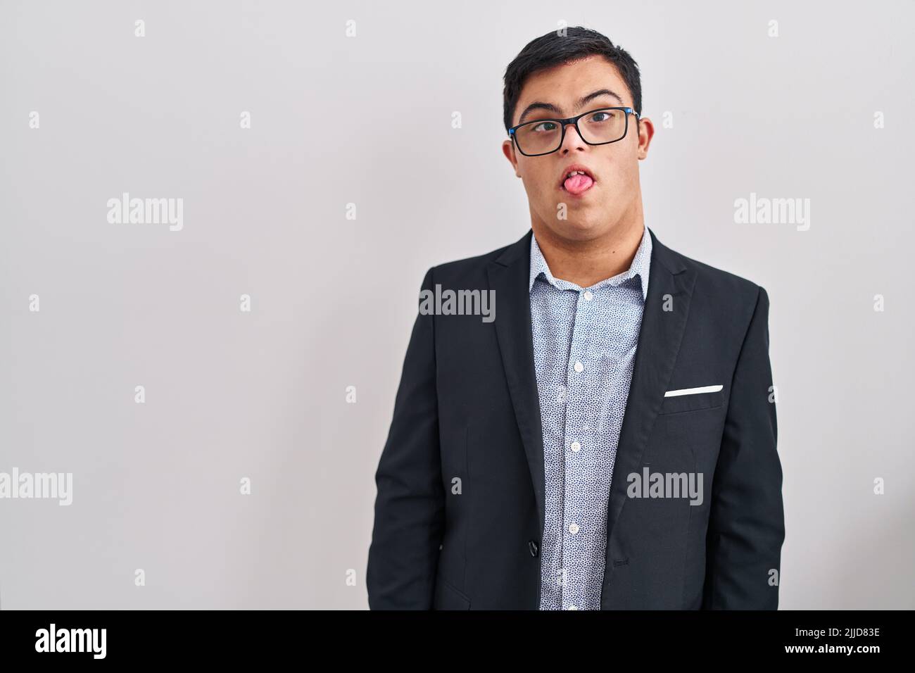 Young hispanic man with down syndrome wearing business style sticking ...