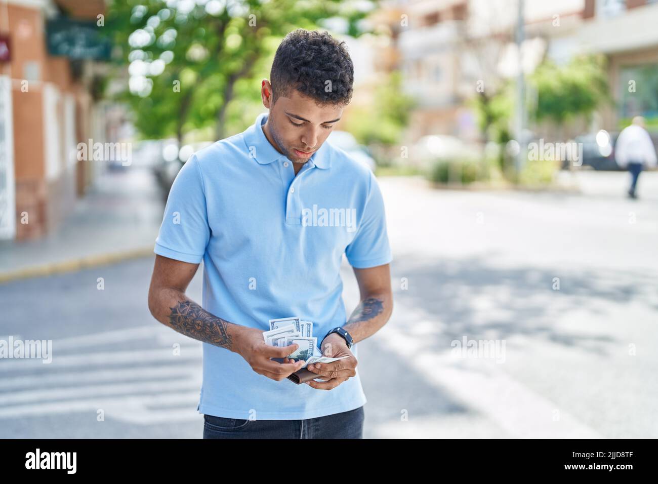 African american man counting dollars at street Stock Photo - Alamy