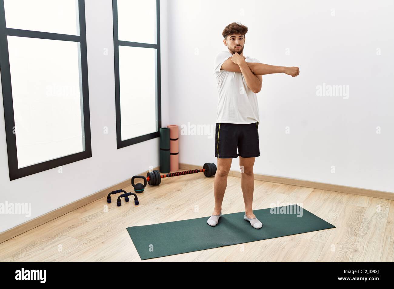 Young arab man stretching at sport center Stock Photo - Alamy
