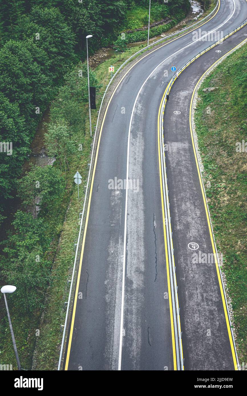Aerial view winding road green alpine forest summer hi-res stock ...