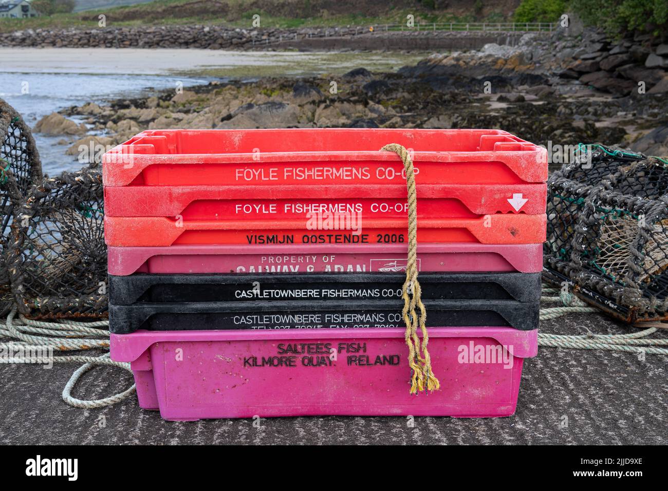 Plastic industrial fish sorting trays on Ventry Pier at Ventry Harbour ...