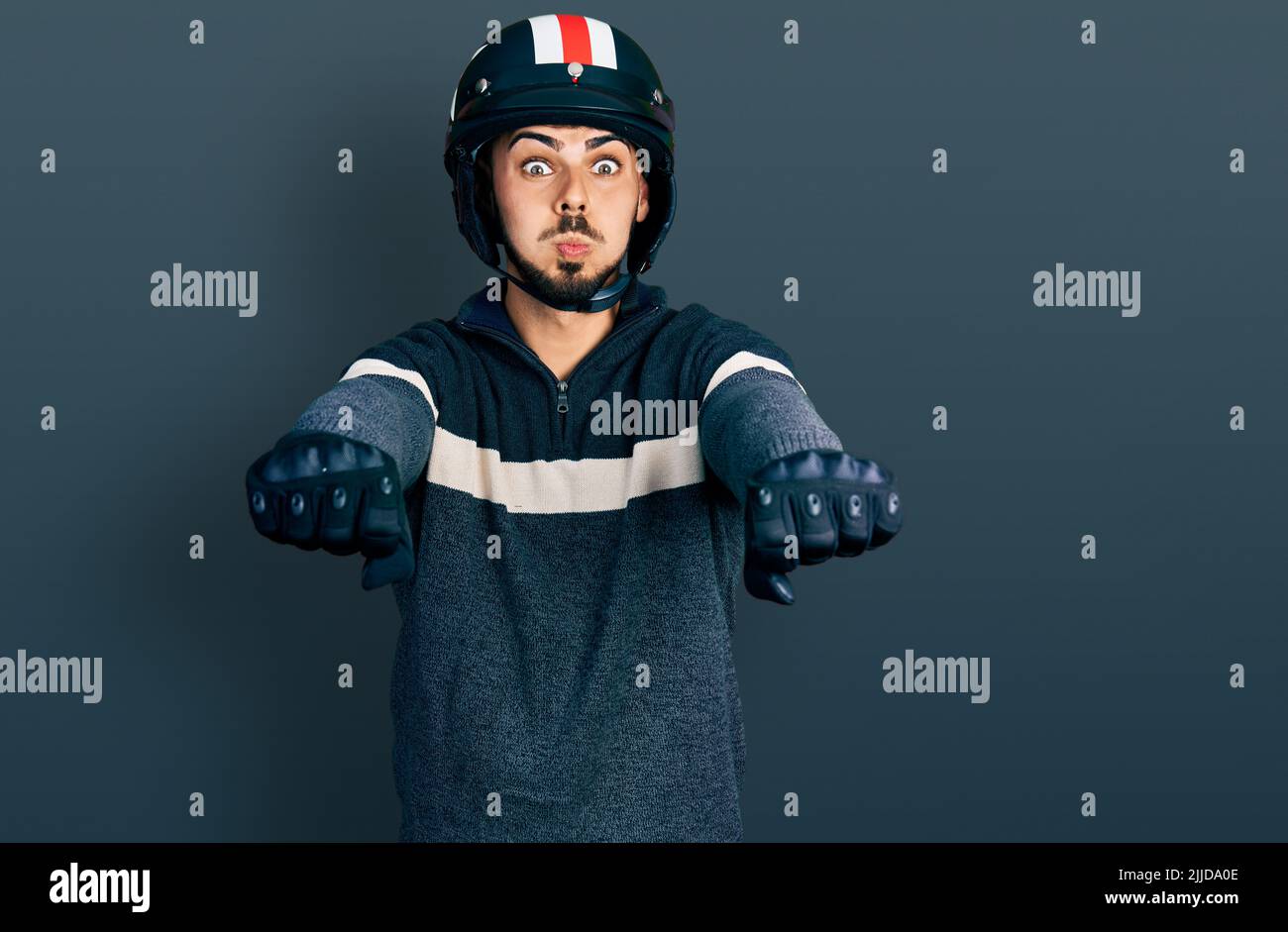 Young Hispanic Man With Beard Wearing Motorcycle Helmet Doing Driving