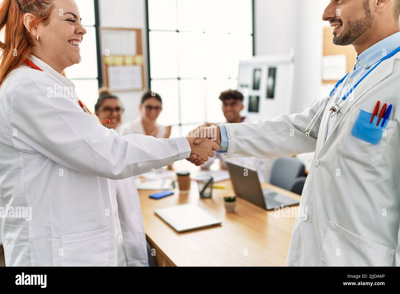 Group of doctor clapping to partners handshake in a medical meeting at ...