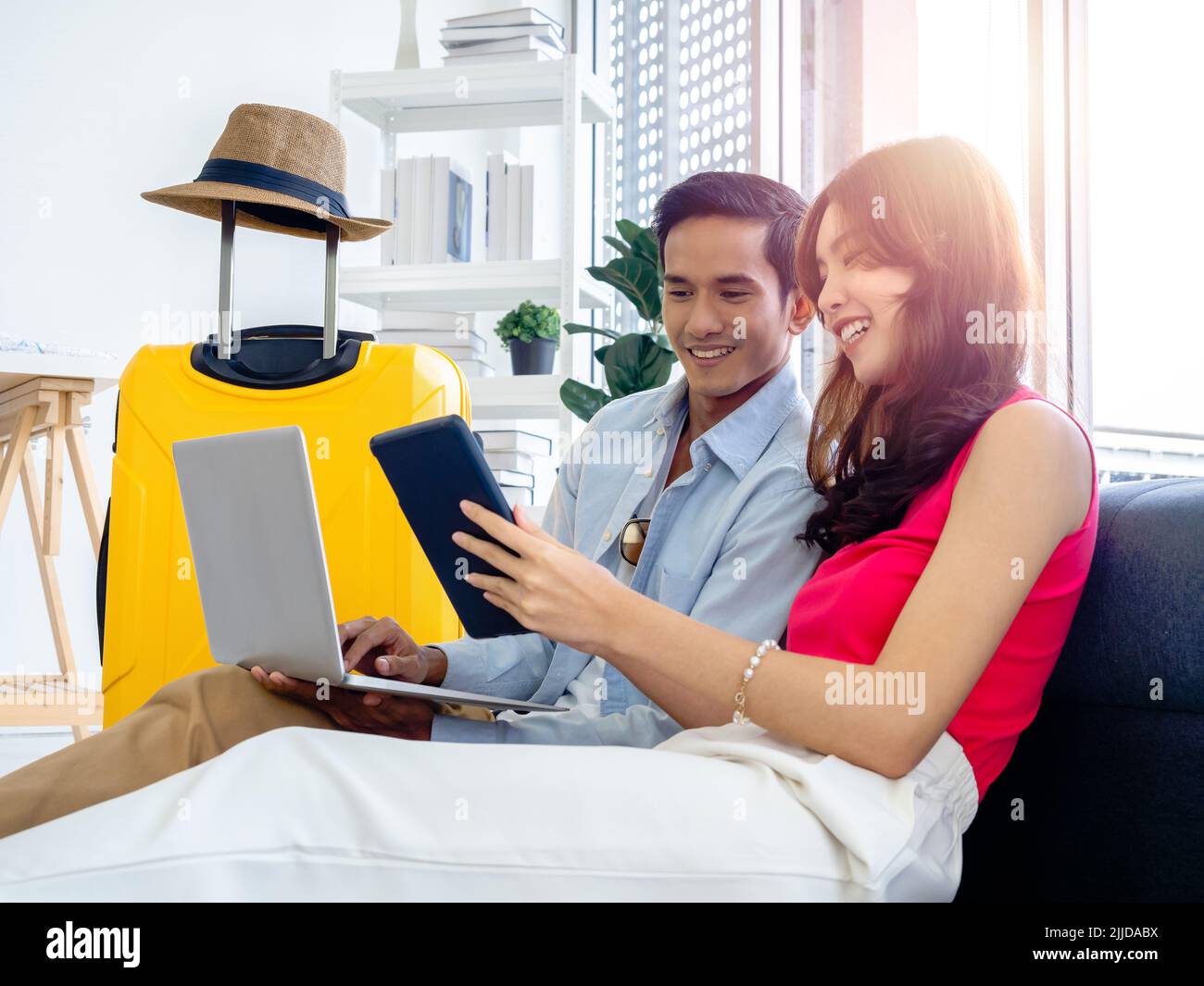 Happy Asian couple, young man and woman looking and using laptop ...