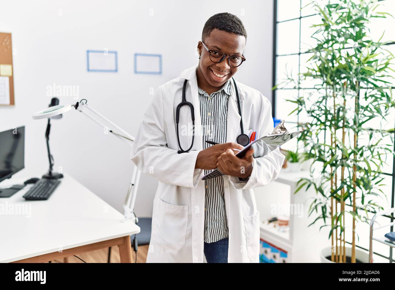 Young african man working as doctor at medical clinic Stock Photo - Alamy