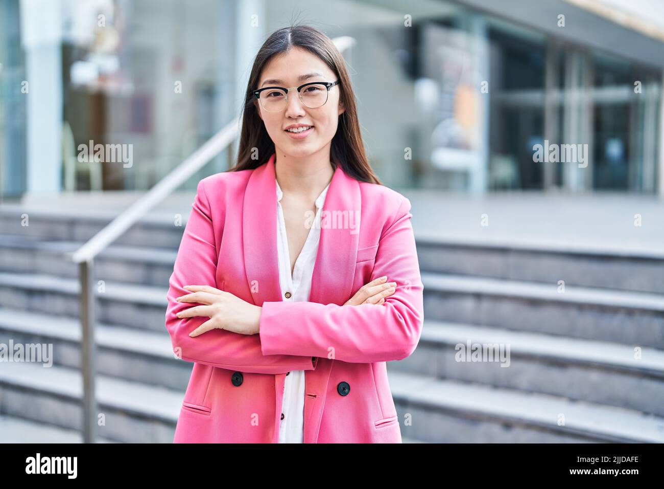 Chinese woman business worker standing with arms crossed gesture at ...