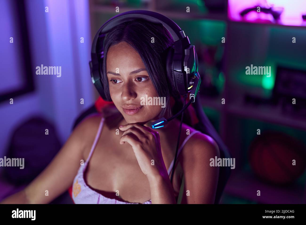 Young hispanic woman streamer playing video game at gaming room Stock ...