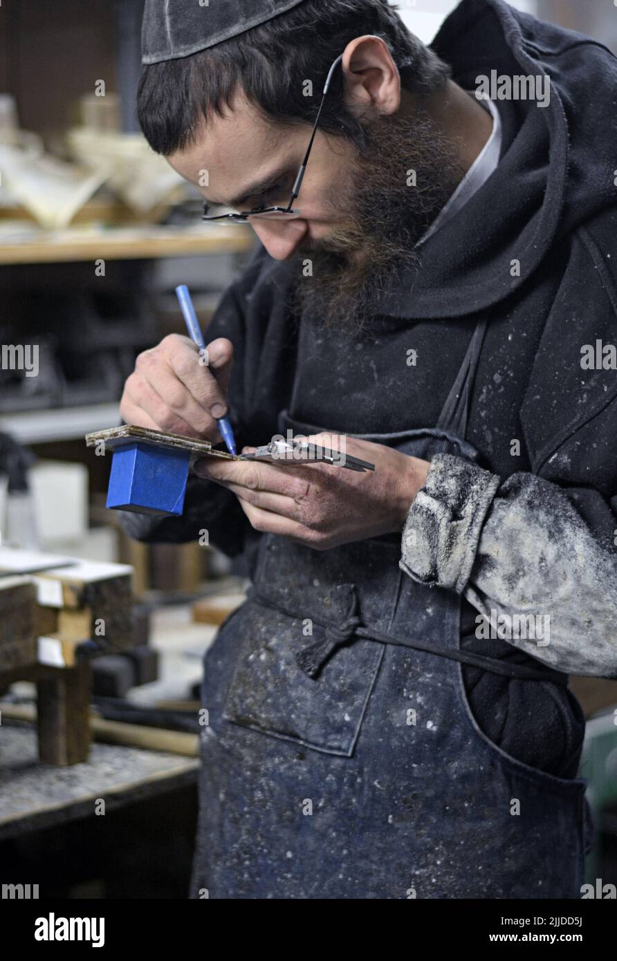 An orthodox Jewish craftsman makes tefillin (phylacteries) in a ...