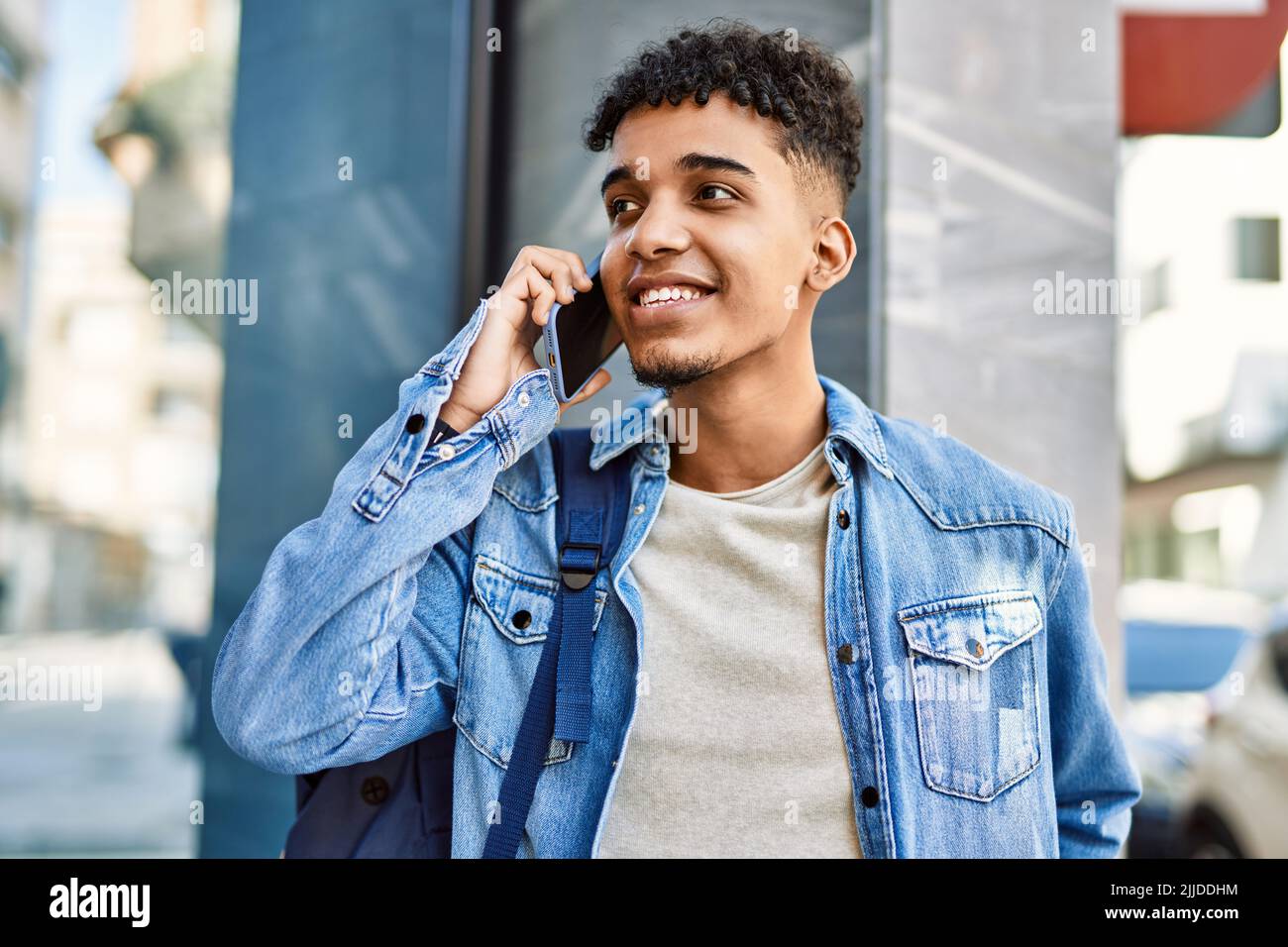 Hispanic young man speaking on the phone at the university Stock Photo ...