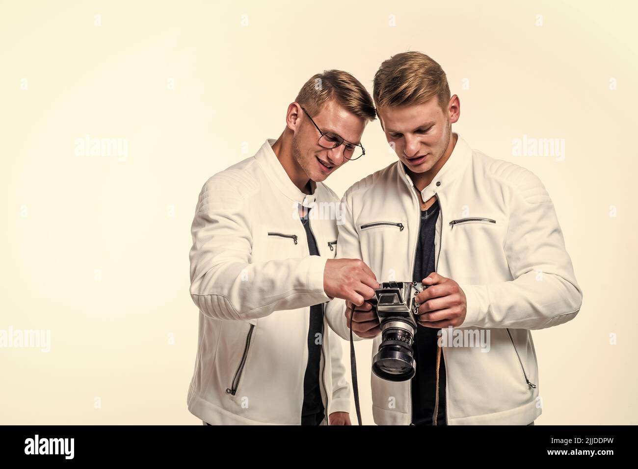 two cousin with retro photo camera. young confident brothers. confident ...