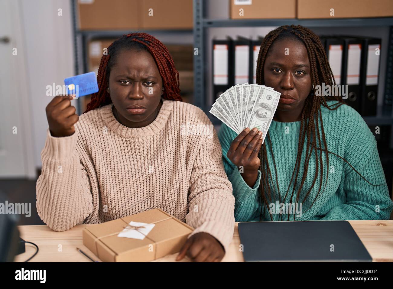 Two african women working at small business ecommerce holding credit ...