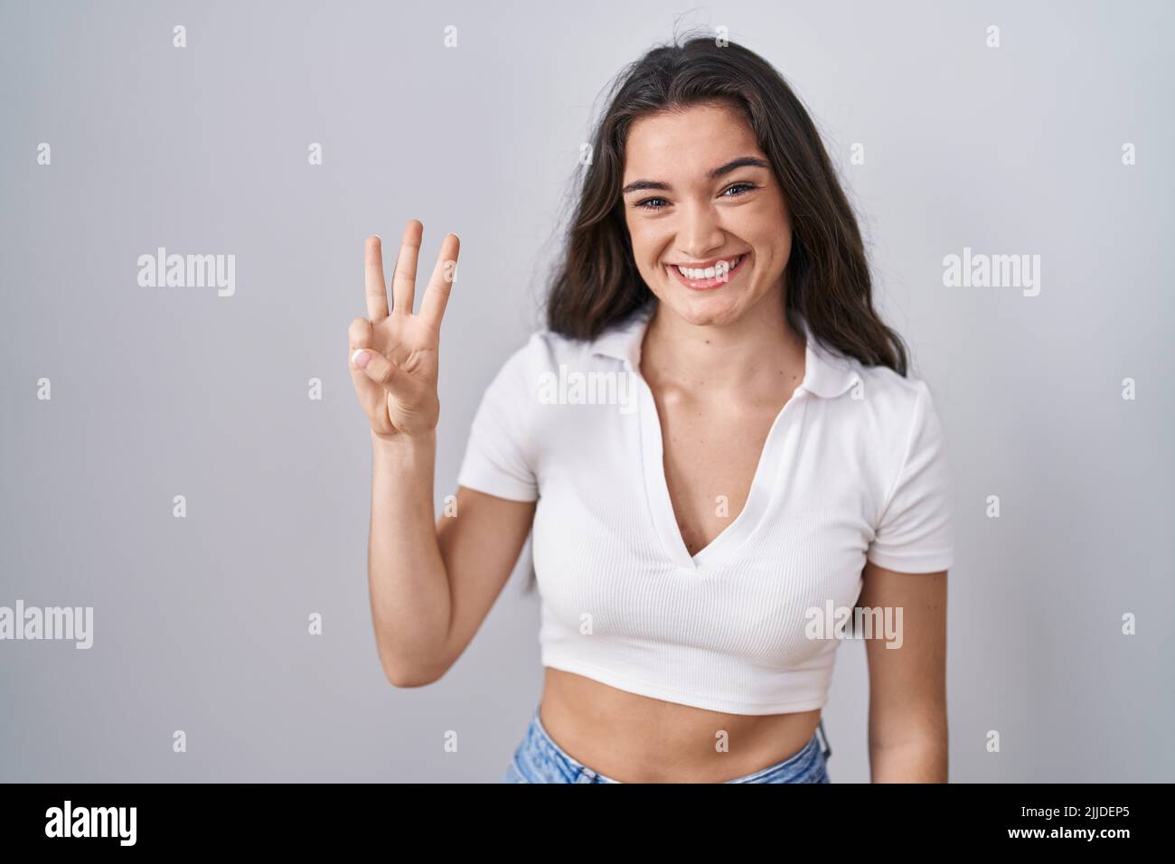 Young teenager girl standing over white background showing and pointing ...